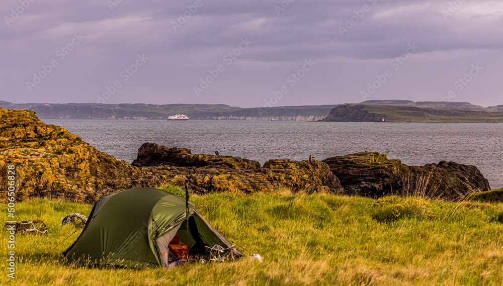 Camping tent om the County Antrim coast as a cruise passenger ship ...