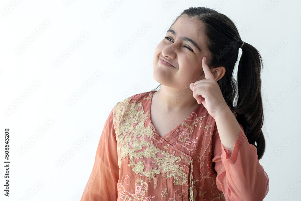 Portrait of Pakistani little girl make a thoughtful gesture, against ...