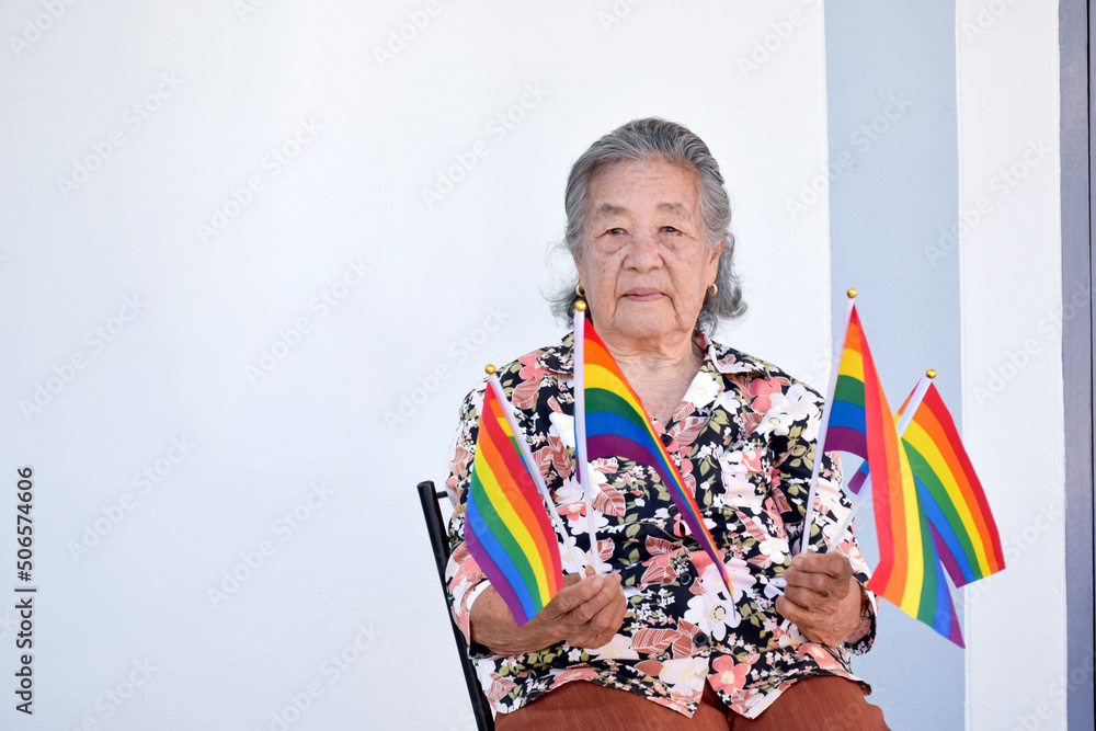 Portrait of asian elderly senior waman sitting on chair and holding ...