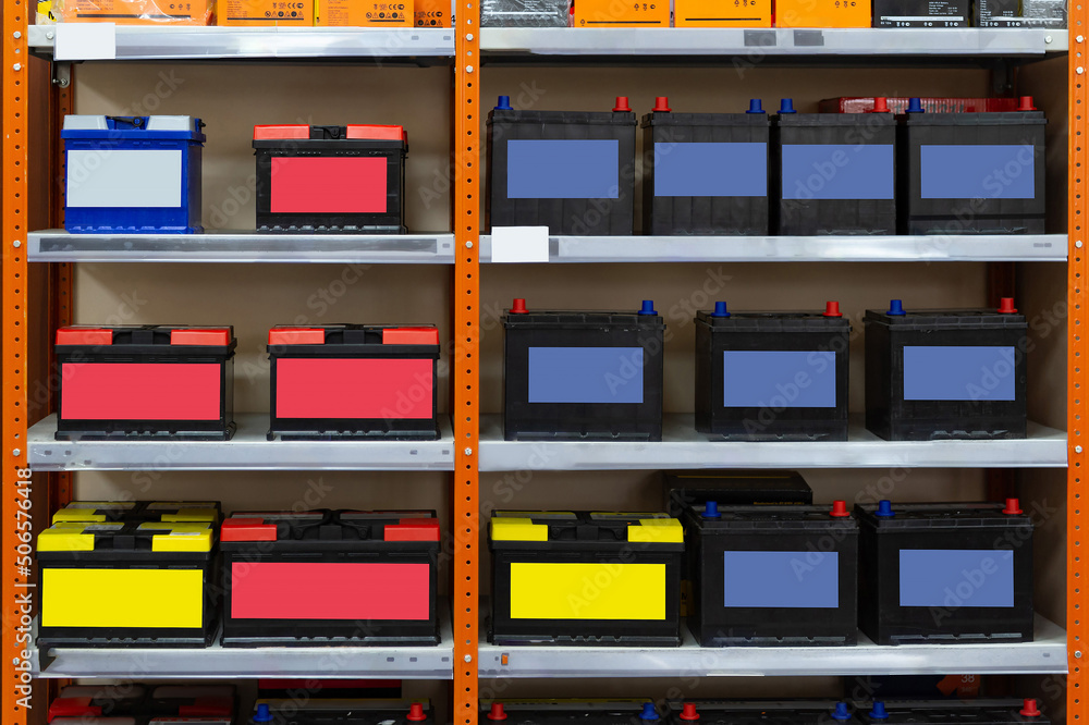 Car batteries on shelves, racks of auto parts store. Sale, maintenance ...