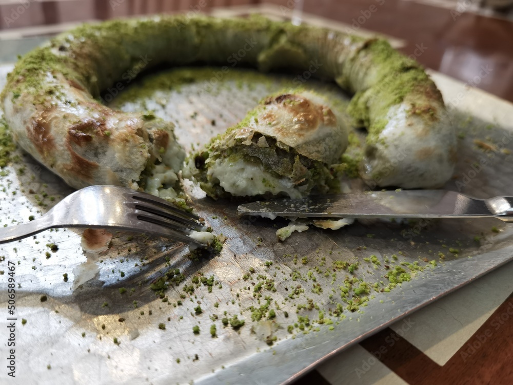 The preparation of a Turkish Katmer dessert, the content of which is ...