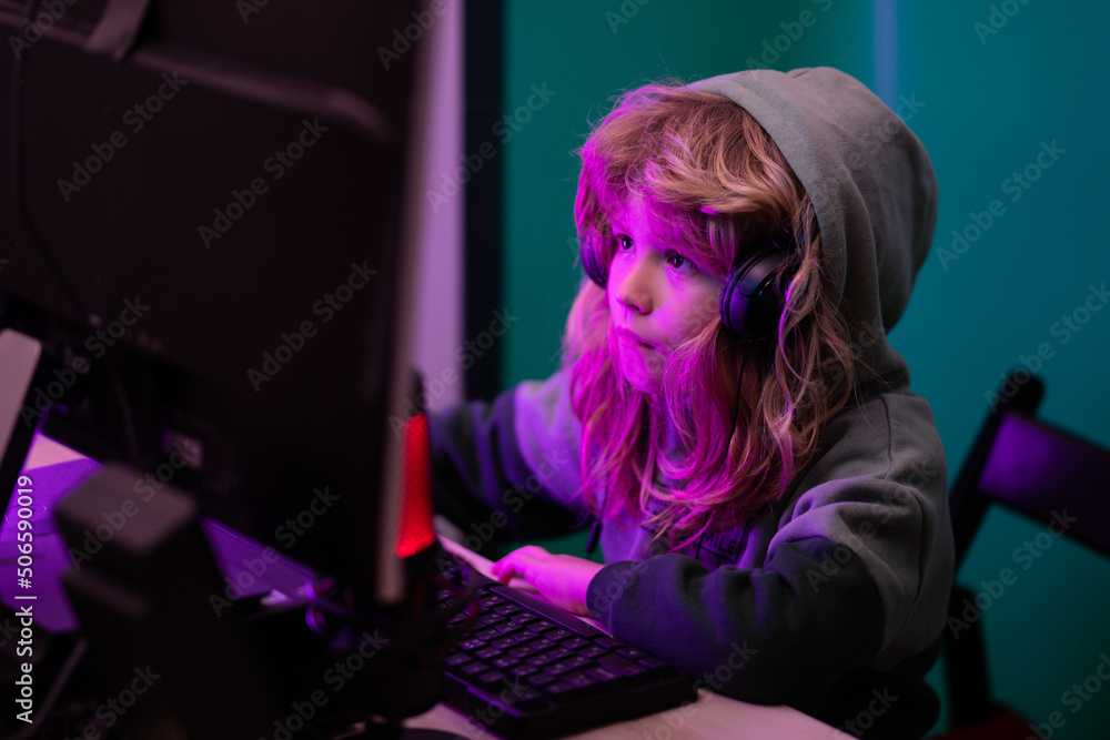 Kid using pc at night. Child with computer in a dark room. Little ...