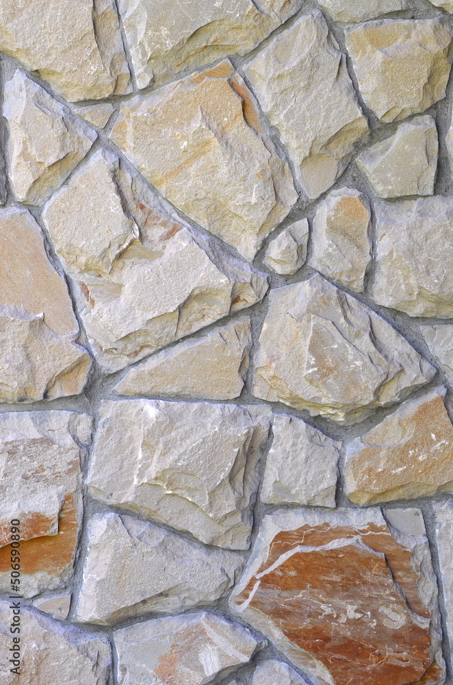 Exterior wall of broken granite stone in gray-brown tones. Wall pattern ...