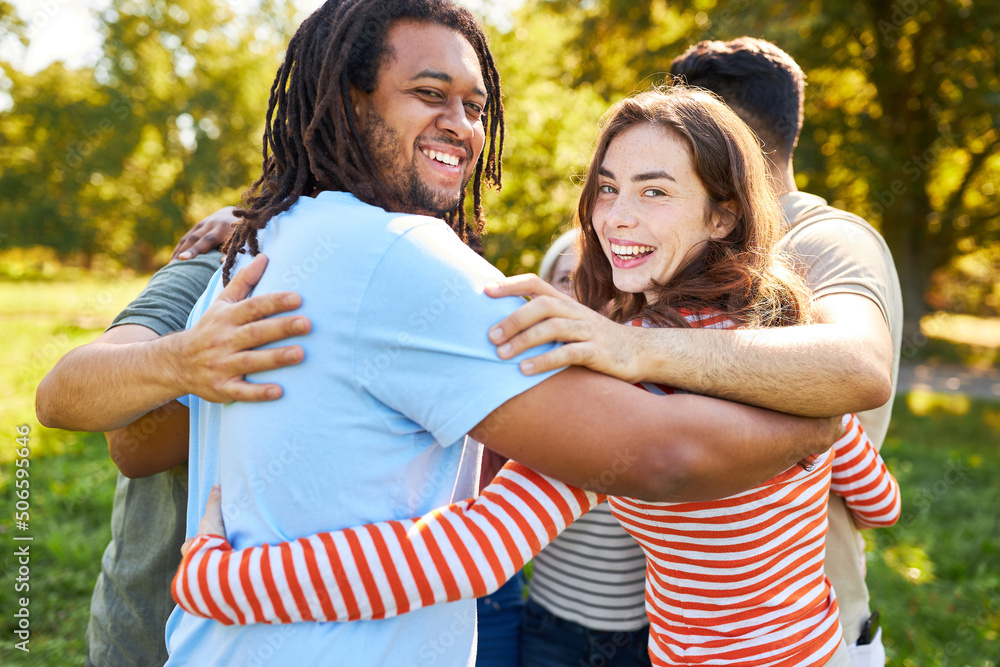 Group of people stand hugging in a circle as a community Stock Photo ...