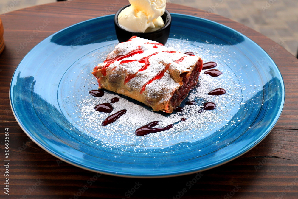 Viennese fruit strudel and ice cream on plate in cafe, restaurant. Hot ...
