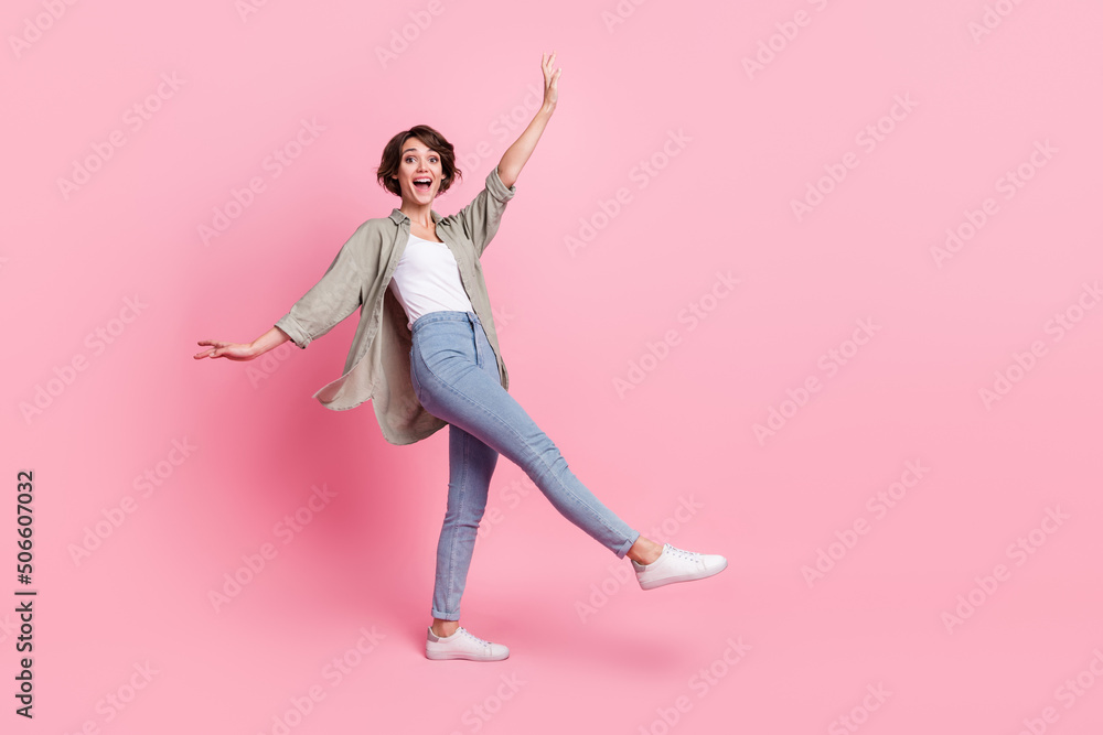 Full length photo of dynamic lady raise hands legs up enjoy rhythm ...