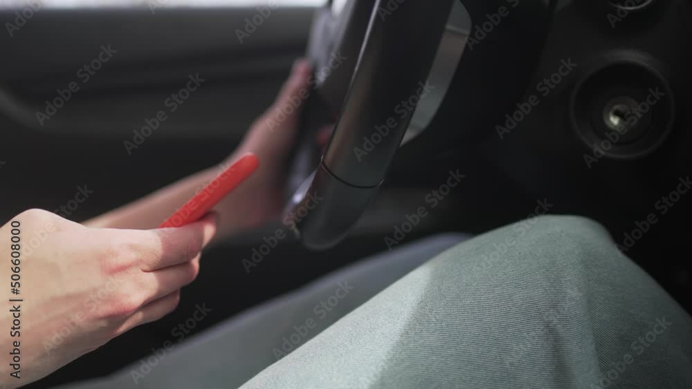 Using a mobile phone in a traffic jam while driving a car. A person ...