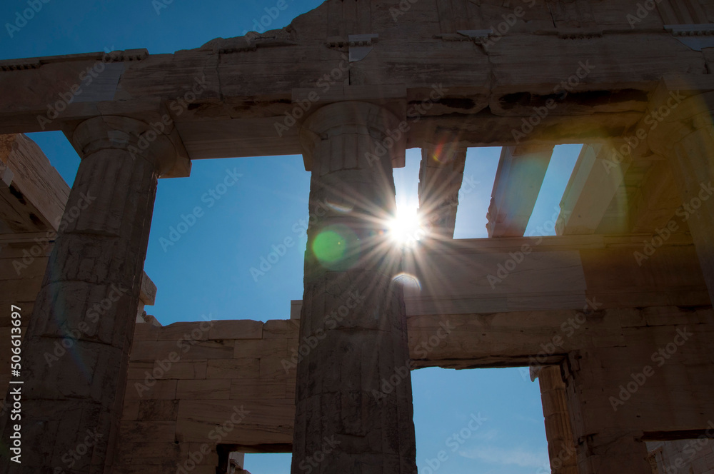 Sunbeam seen through ancient temple stone columns and rafters ruins on ...