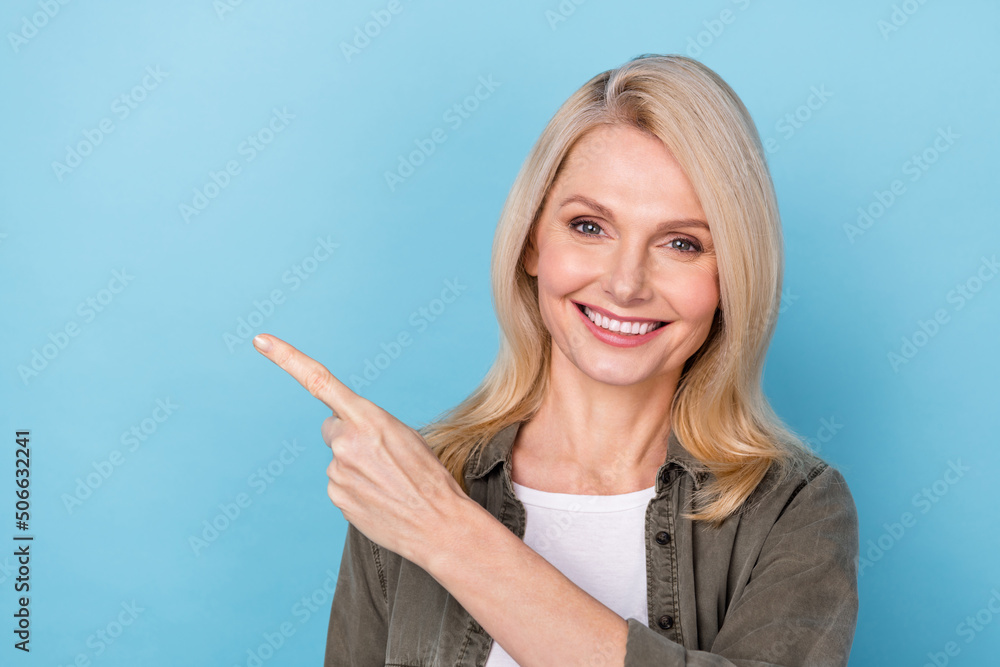 Portrait of positive middle aged lady point finger empty space present ...