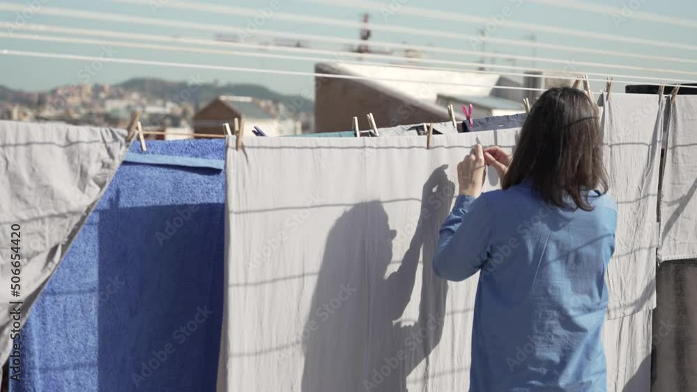 Stockvideon Brunette woman with blue shirt and hair down is hanging ...