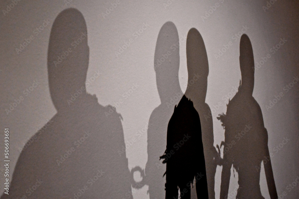 Human Shadows on the wall. Illumination by different intensity lamps ...