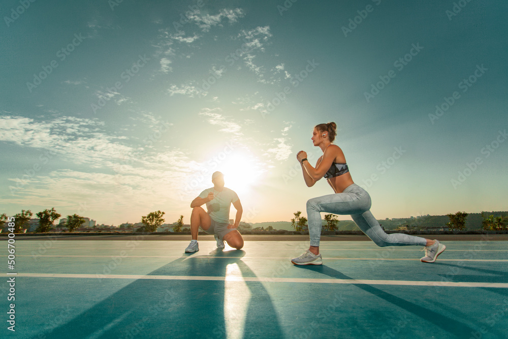 Instructor and athlete runner on the track. The athletics marks the ...