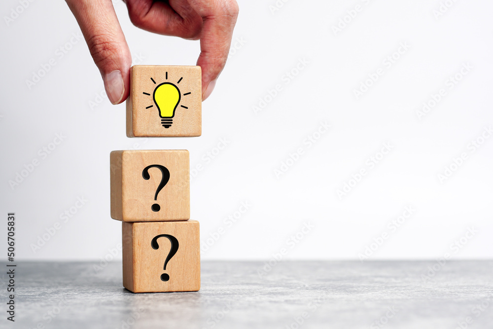 Concept creative idea and innovation, Hand picked wooden cube block with light bulb icon and ...