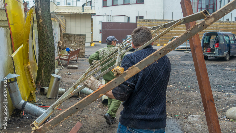 Removal of construction debris. Loading the garbage can waste ...