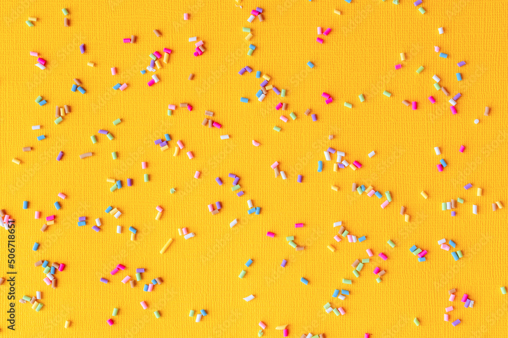 Colorful sprinkles on yellow background. Concept of fun and celebration ...