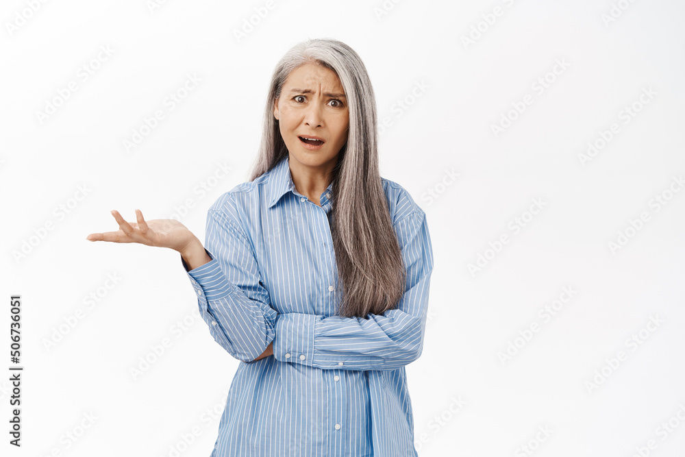 Confused japanese middle aged woman looking questioned and frustrated ...