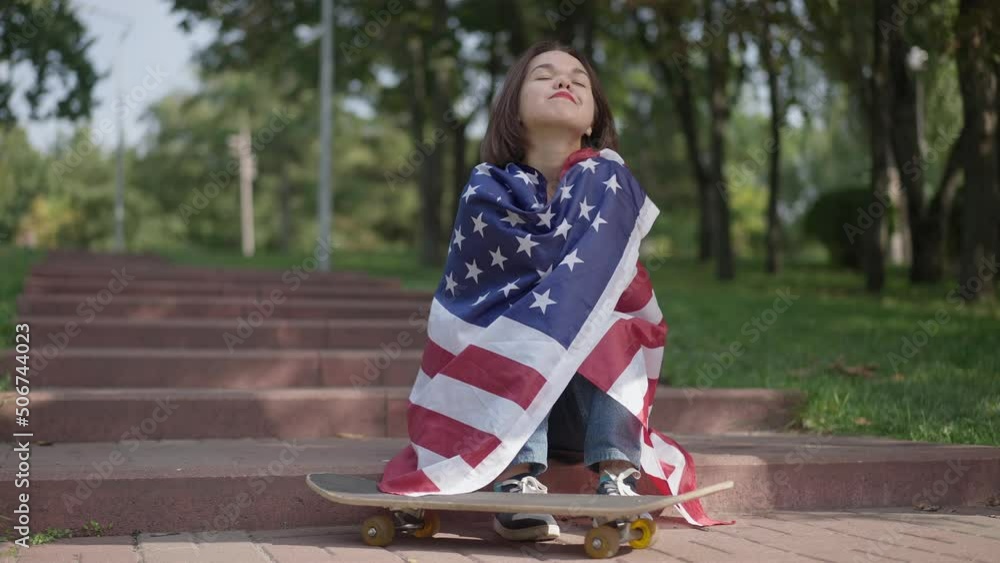 Sportive young woman with dwarfism wrapping in American flag smiling ...