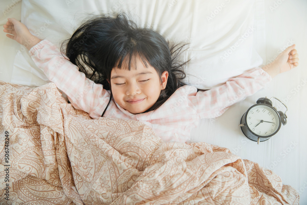 Asian child girl enjoys sunny morning. Good time at home. Kid wakes up ... Asian child girl enjoys sunny morning. Good time at home. Kid wakes up ...