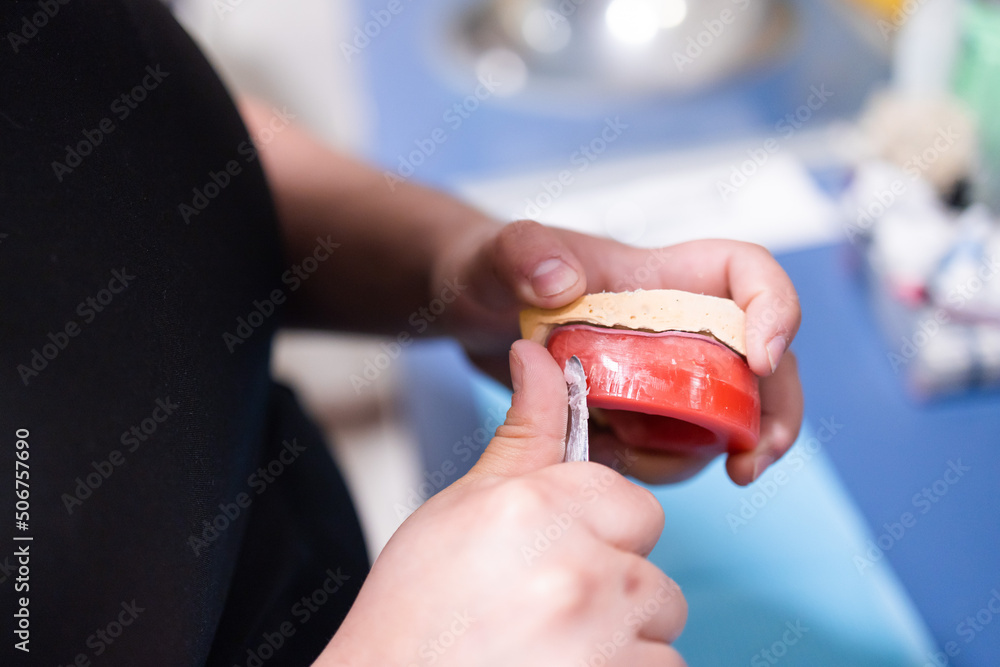 Dentist holding an artificial lower jaw. Dental Prosthesis. Zirconium ...