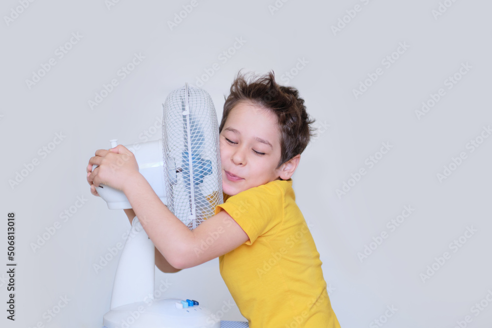Little boy with fan relaxing at home. Summer heat. sunny hot summer day ...