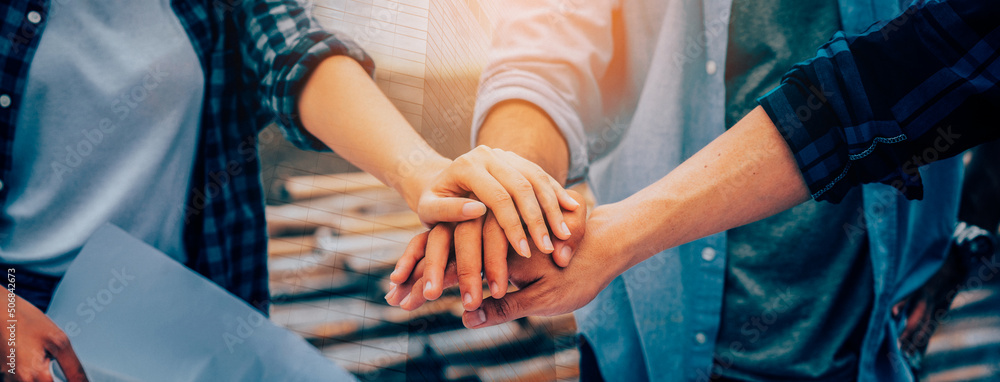 Closeup of team engineer construction workers join hands together on ...