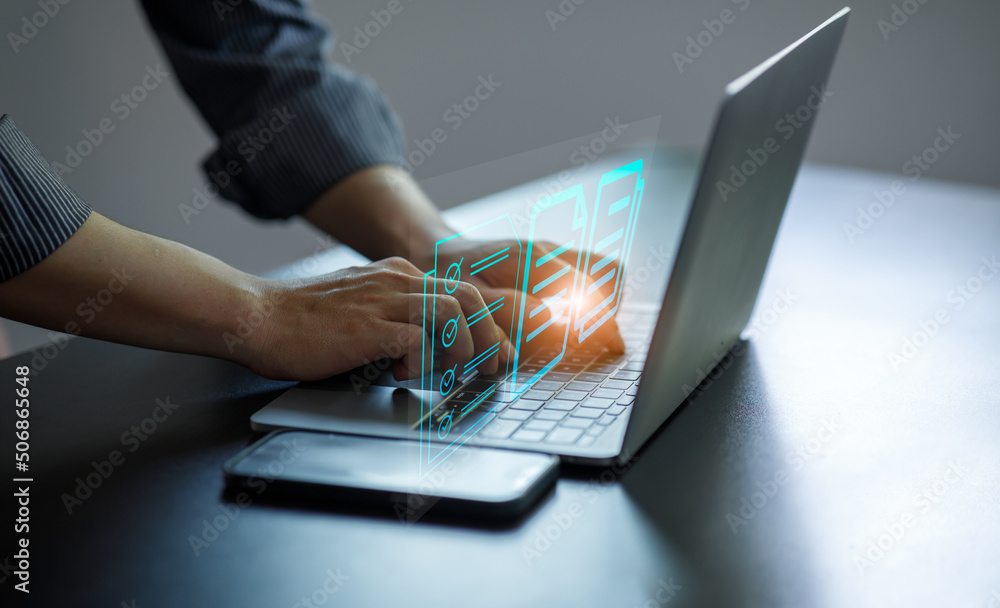 Business Hand using laptop computer with virtual screen and document ...