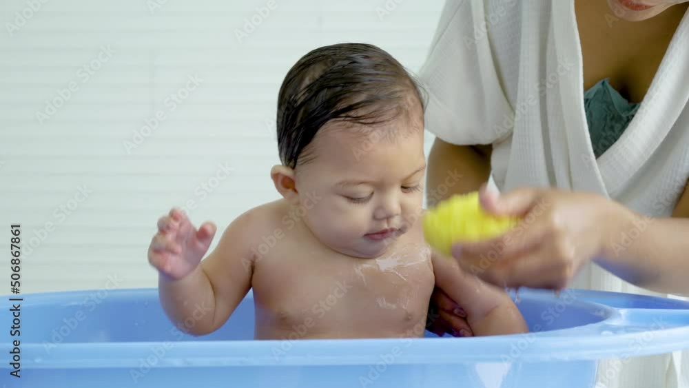 Hygienic procedures for newborn, Mother bathing her daughter in warm ...