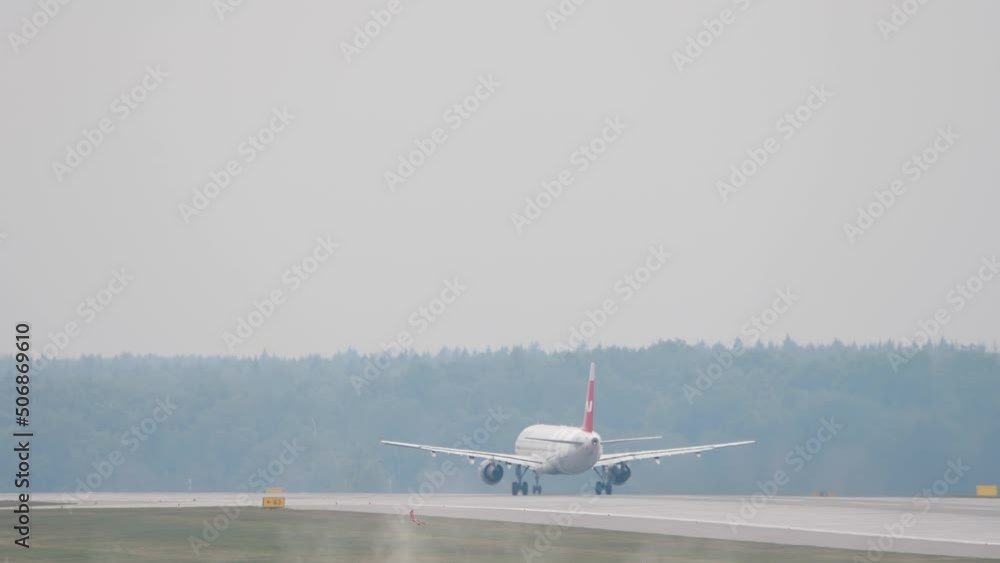 Passenger airplane takes off, departure. Rear view, the jet plane is ...