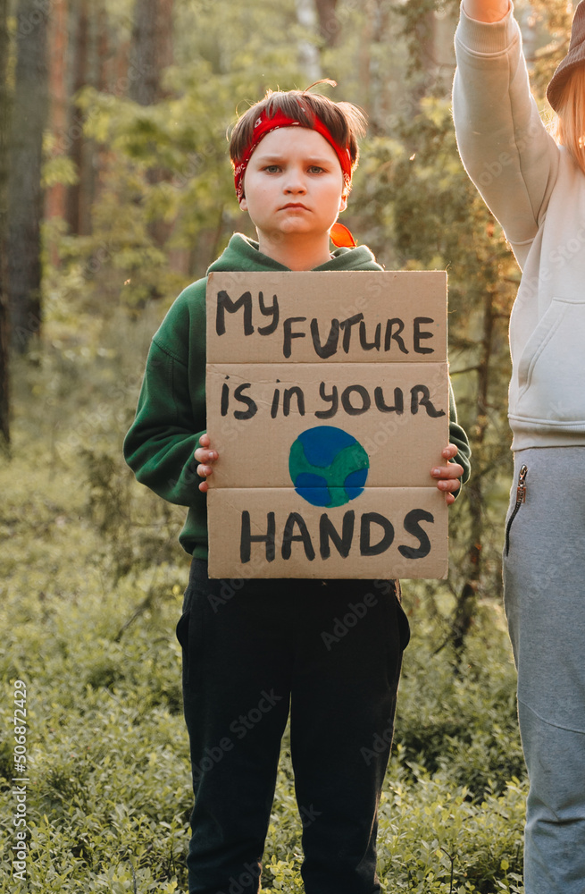 teen boy looking to camera with My Future in Your Hands poster support ...