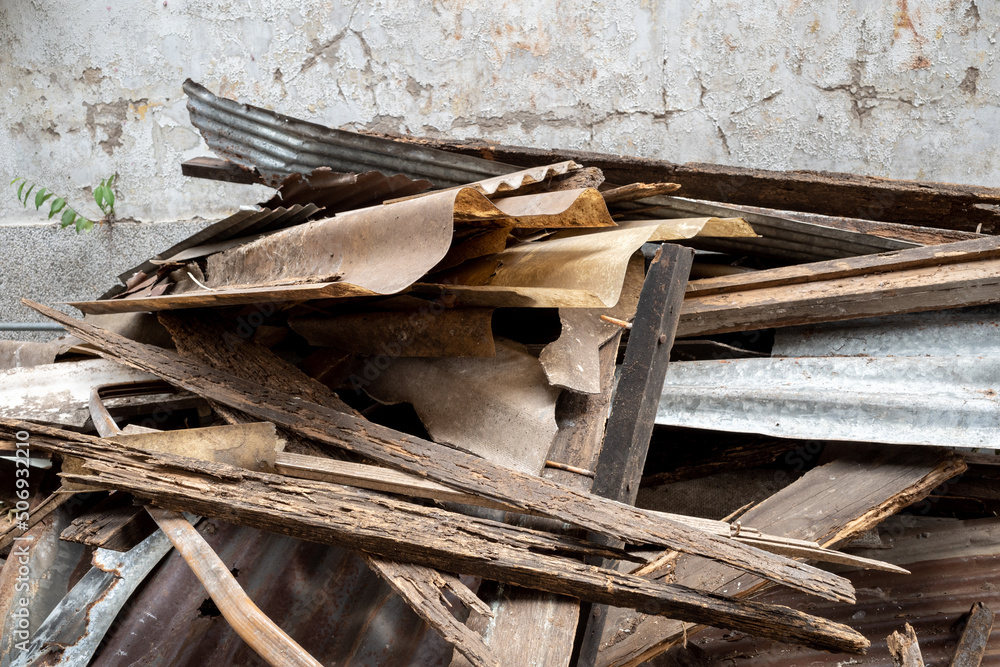 Waste of demolishing material building, heap of timber, wood, and wave ...