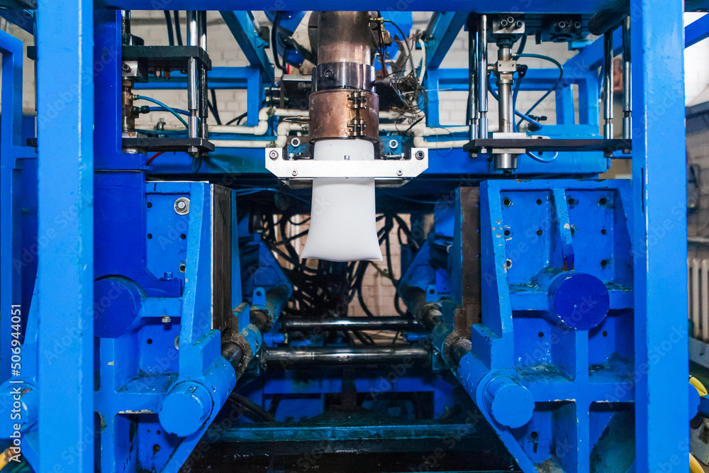 The process of blowing plastic tanks in extrusion equipment. Molten ...