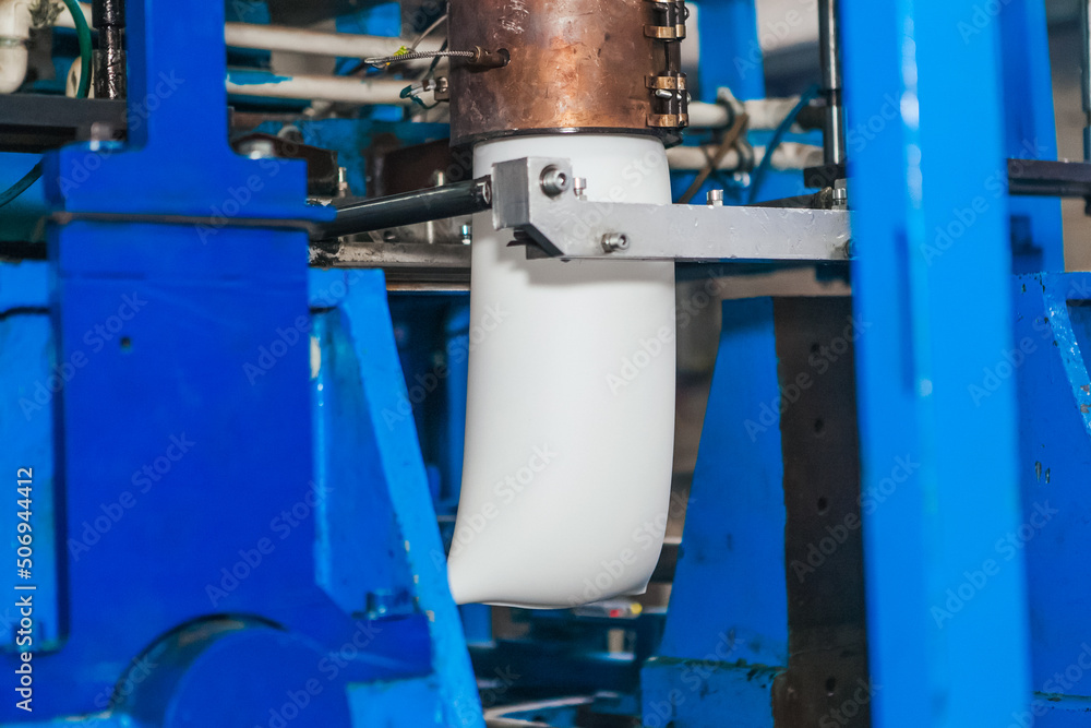 The process of blowing plastic tanks in extrusion equipment. Molten ...