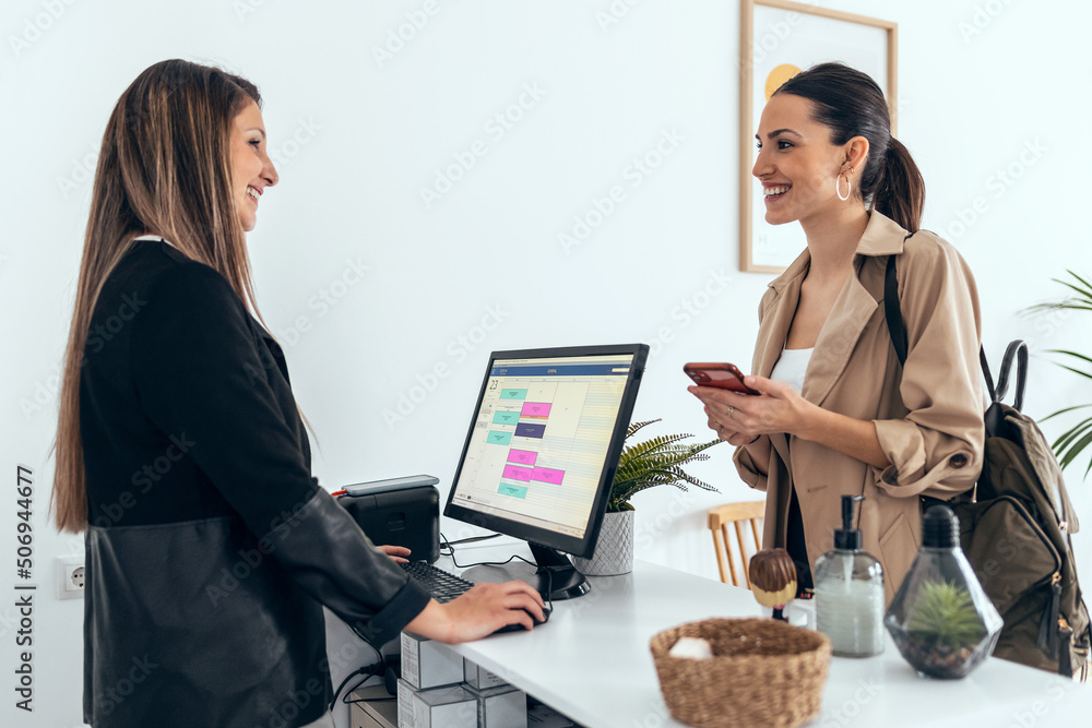 Beautiful young woman requesting an appointment to beautician in ...