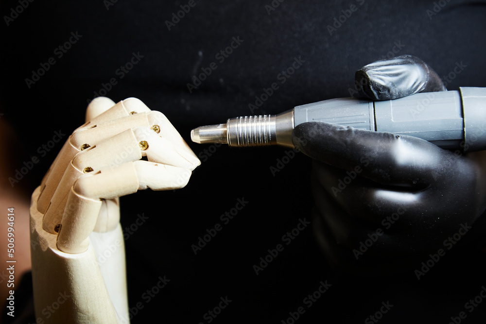 Manicure in the salon, wooden doll hand with a manicure and pedicure ...