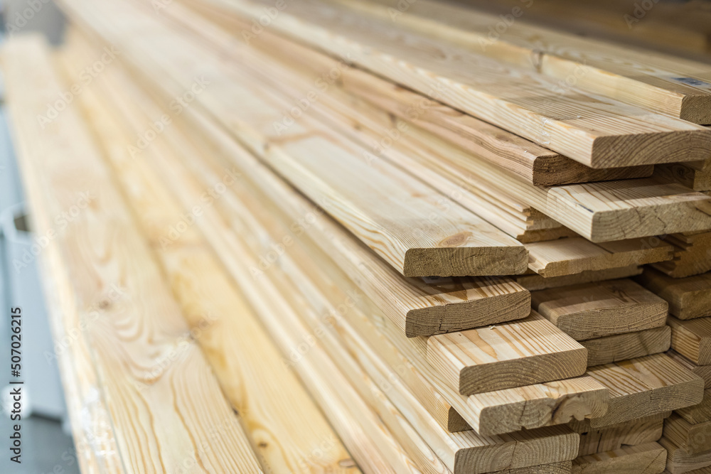 Flat wooden boards in a stack. Building materials. Beams for carpentry ...