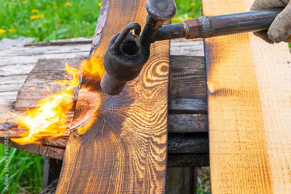 Wood processing with fire from a gas burner for firing and revealing ...