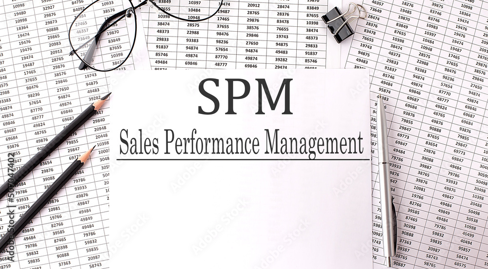 Paper with SPM - Sales Performance Management on a table on charts ...