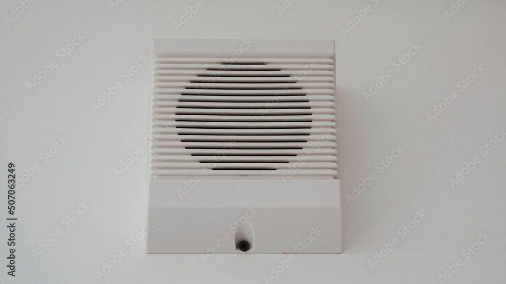 White loudspeaker of the fire system on white wall. Fire safety speaker ...