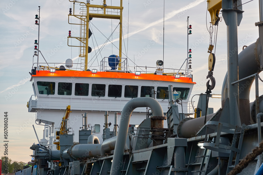 Trailing suction hopper dredger ship anchored in cargo port terminal ...