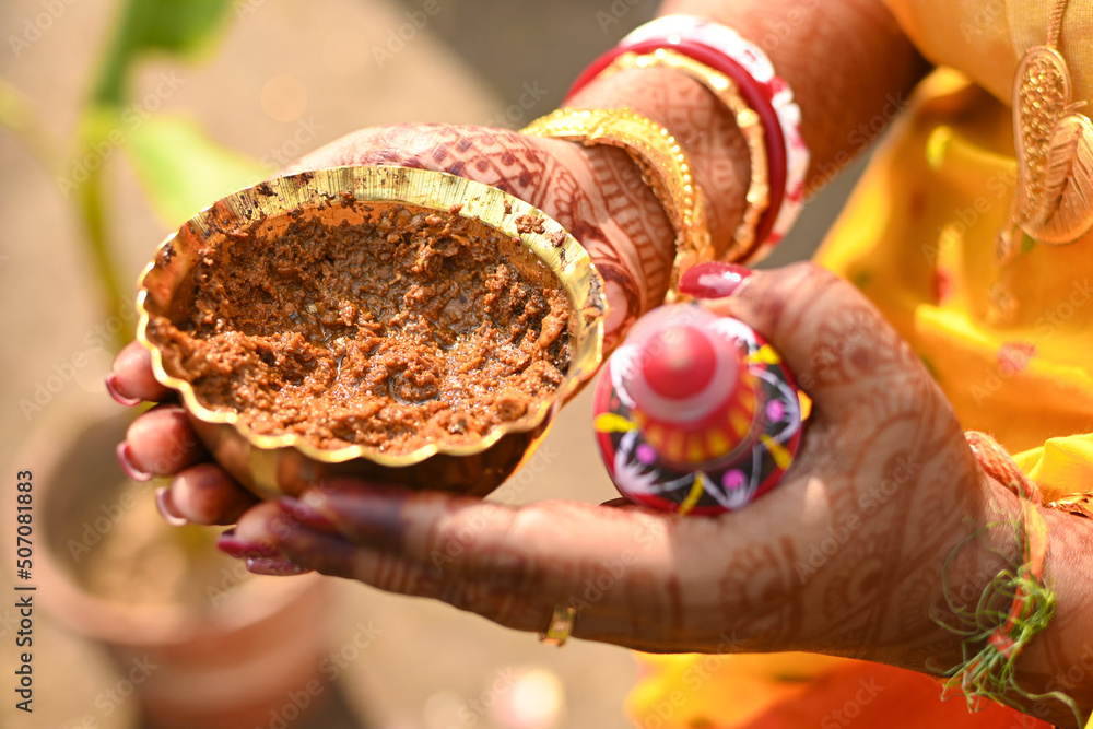 Indian Bride holding Turmeric paste or haldi paste in hand in a Hindu ...