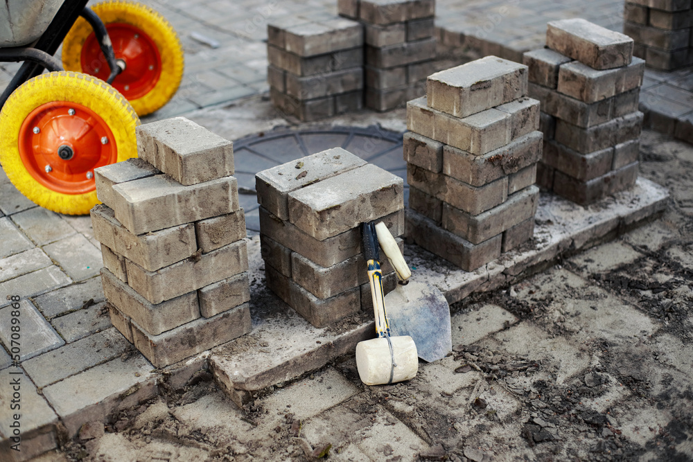 View of new paving slabs and concrete blocks on summer day at ...
