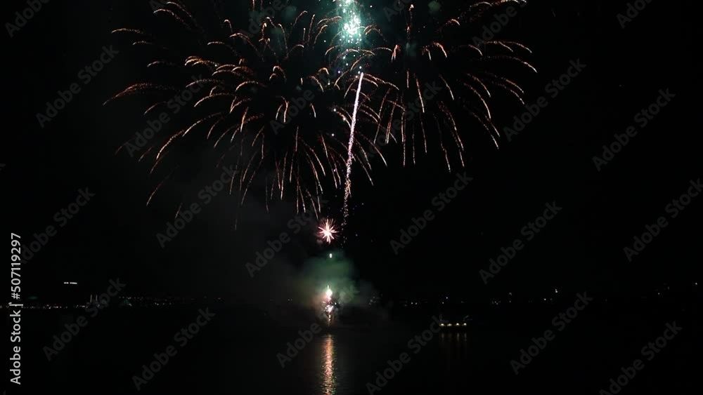 Start of the fireworks launch scene from the water. Multiple salute ...