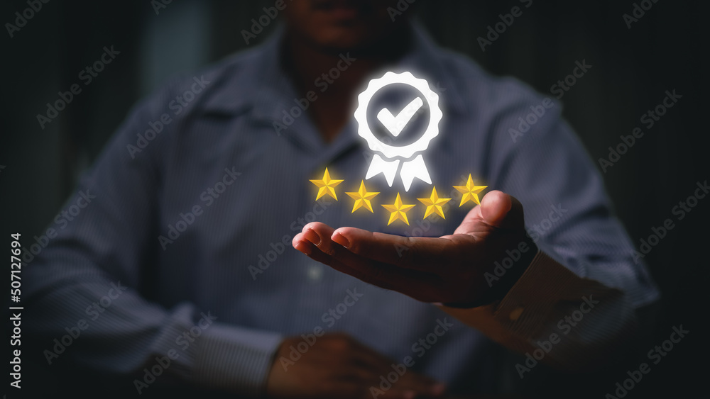 Businessman holding and showing the best quality assurance with golden ...