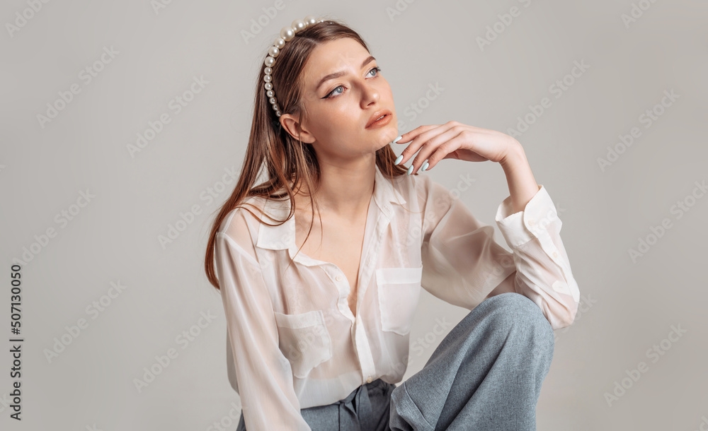 Beautiful model posing reclining head back and holding an elbow on her ...