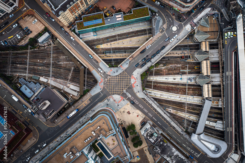 Aerial top down view of a road and railway junction in a bustling city ...