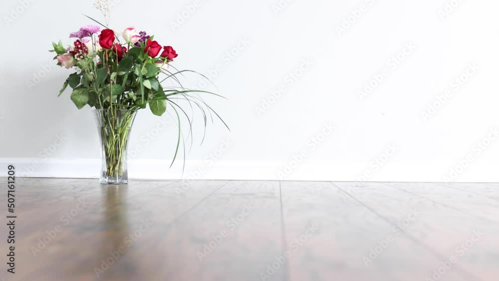 Sliding on the high floor of an empty room in front of flower ...