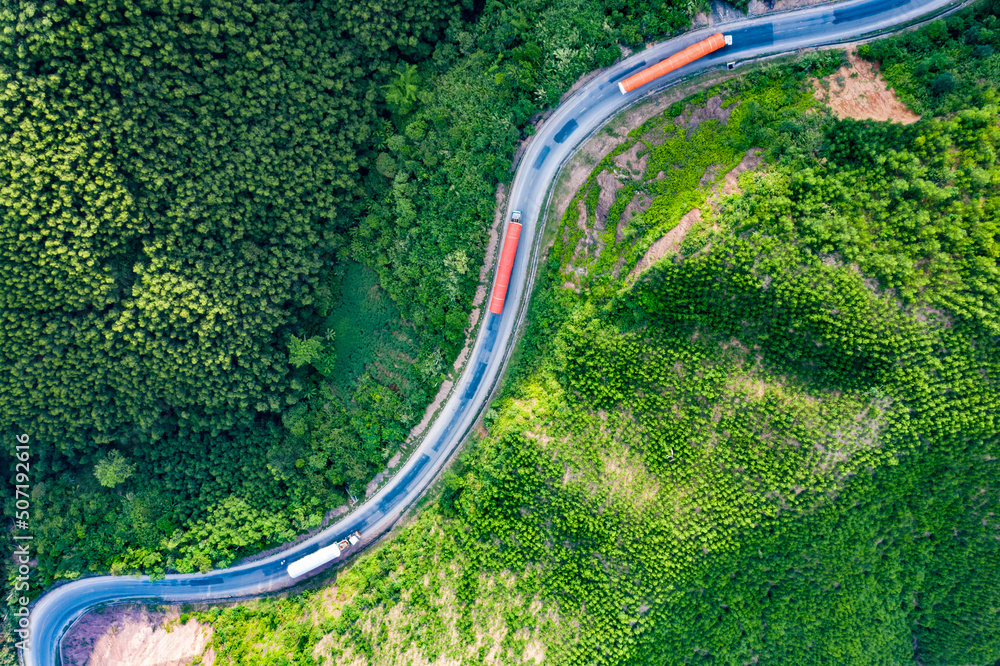 Transporting wind turbine propeller through curvy jungle road. Clean ...