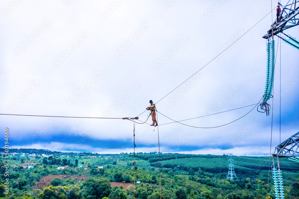 Silhouette electrician work installation of electricity lines in high ...