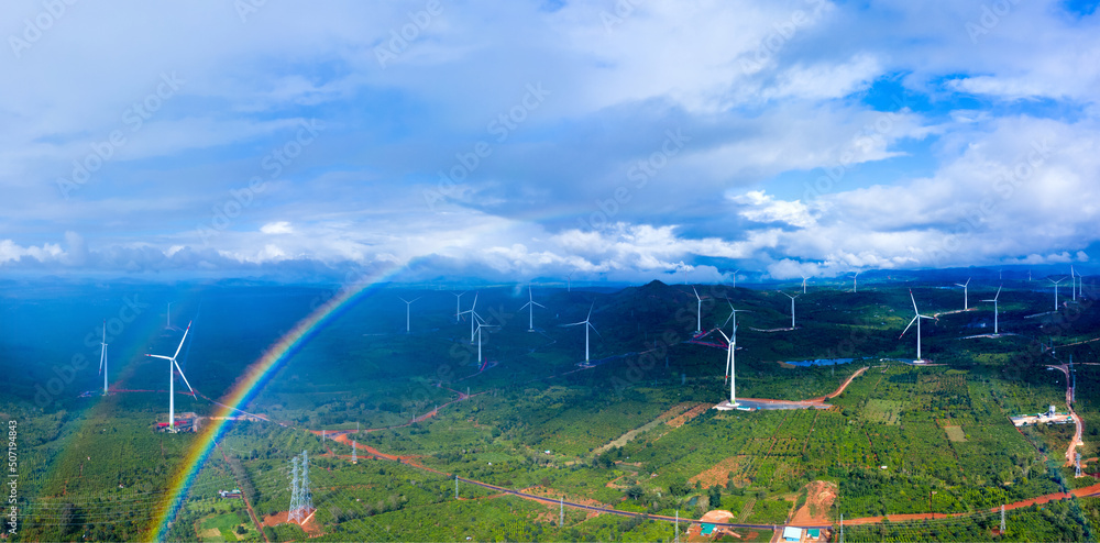 Wind turbine towers farm in a big field to generate electricity. Clean ...