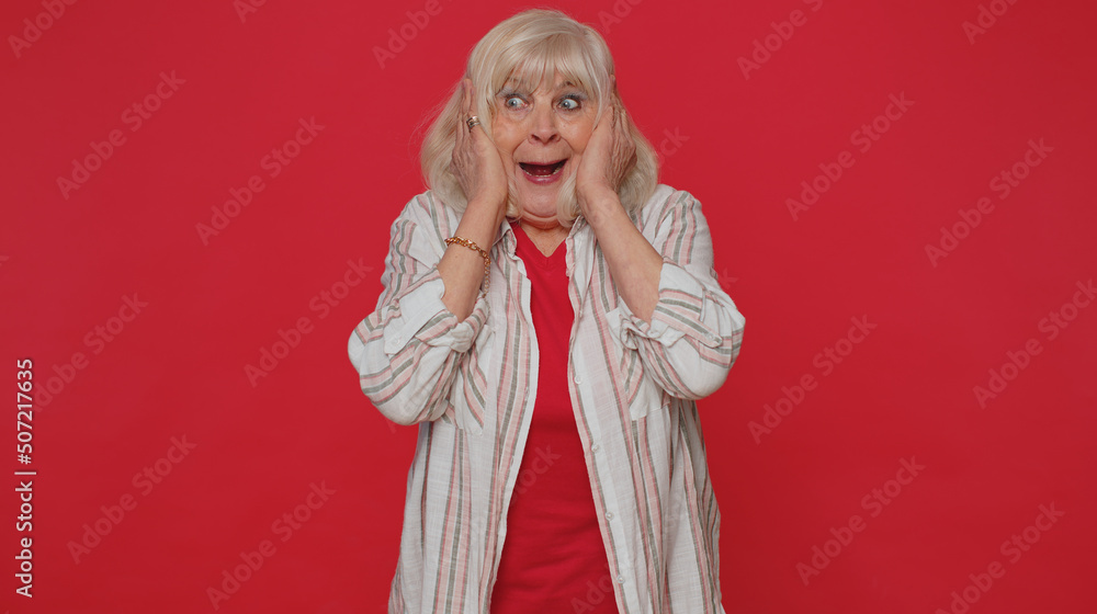 Elderly mature woman scared fearful, covering ears with hands, closing ...